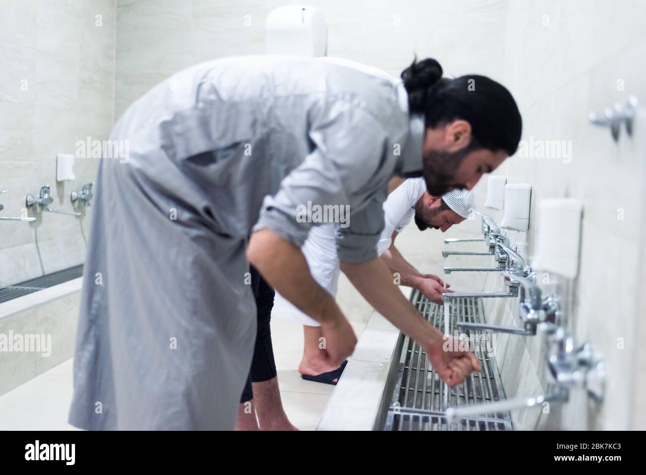Two young Muslim people taking ablution for prayer. Islamic Religious ...
