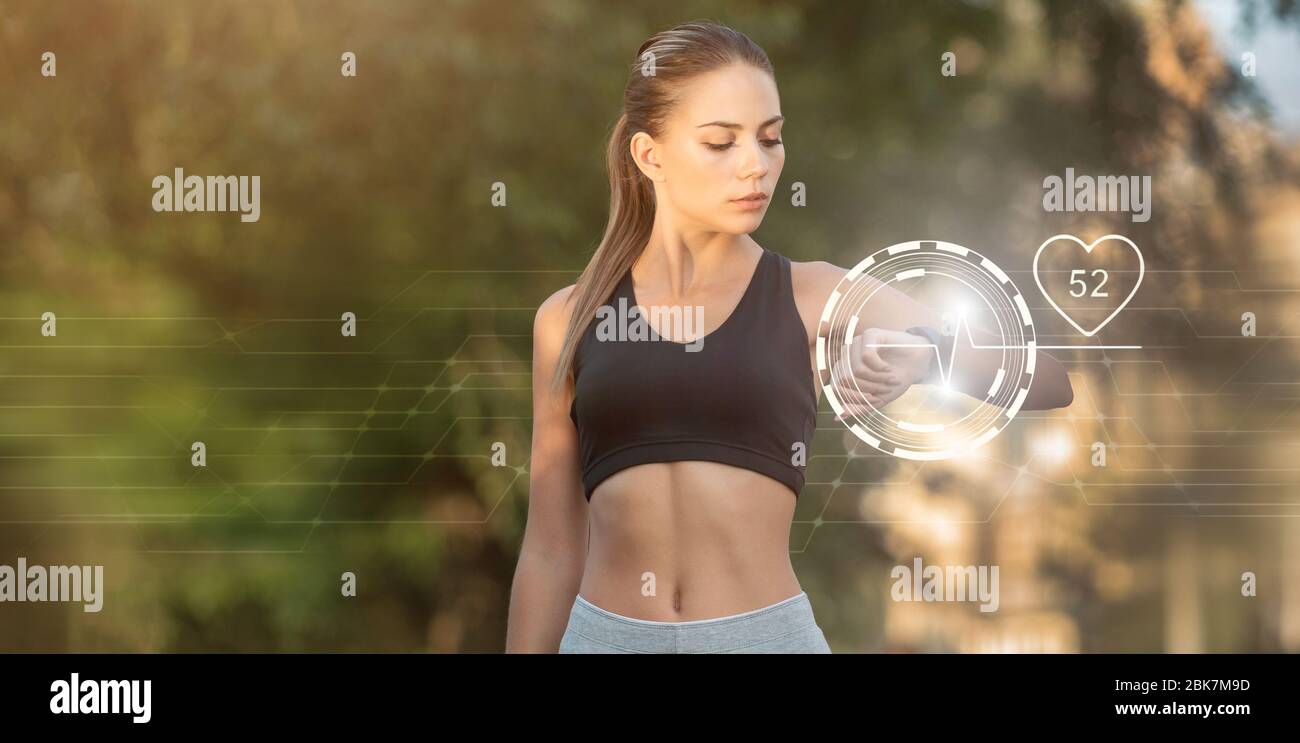 Beautiful sporty girl looking at smart watch Stock Photo - Alamy