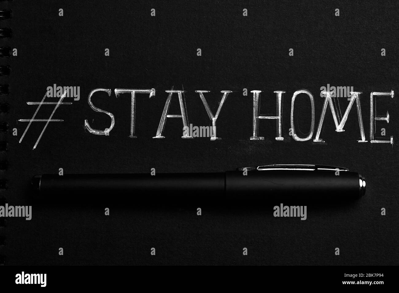 Stay at home, text. Headline inscription on black paper background ...