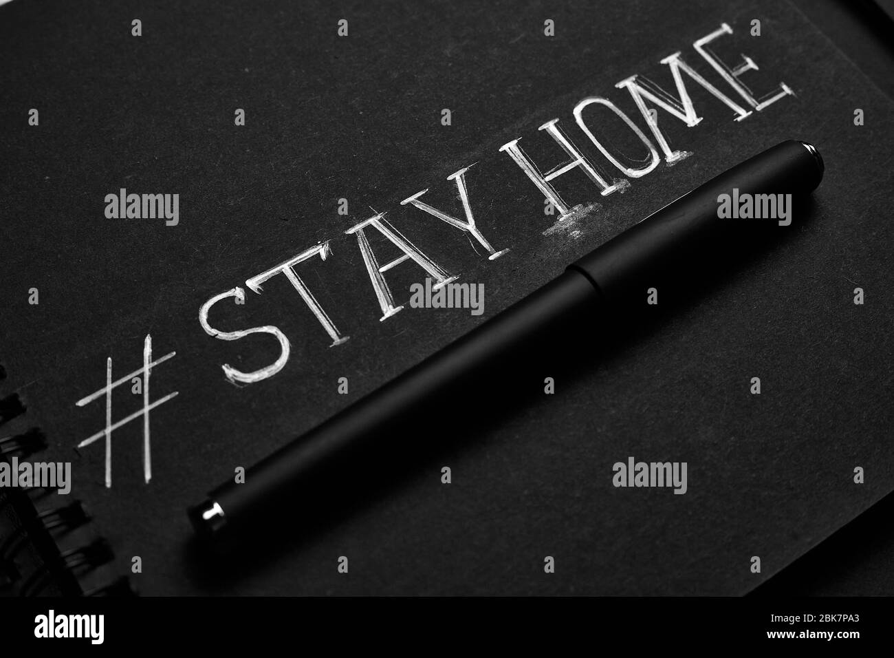 Stay at home, text. Headline inscription on black paper background ...