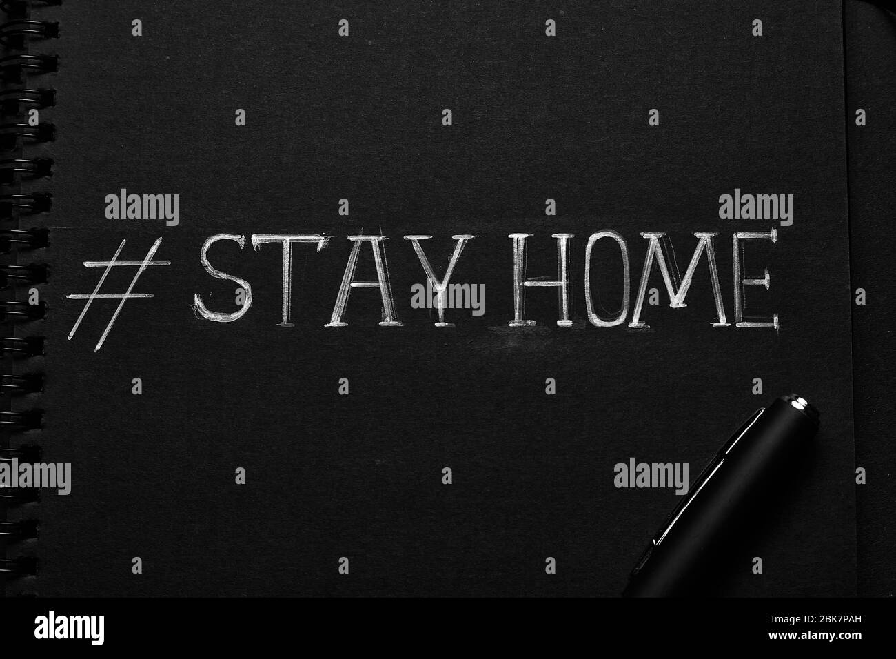 Stay at home, text. Headline inscription on black paper background ...