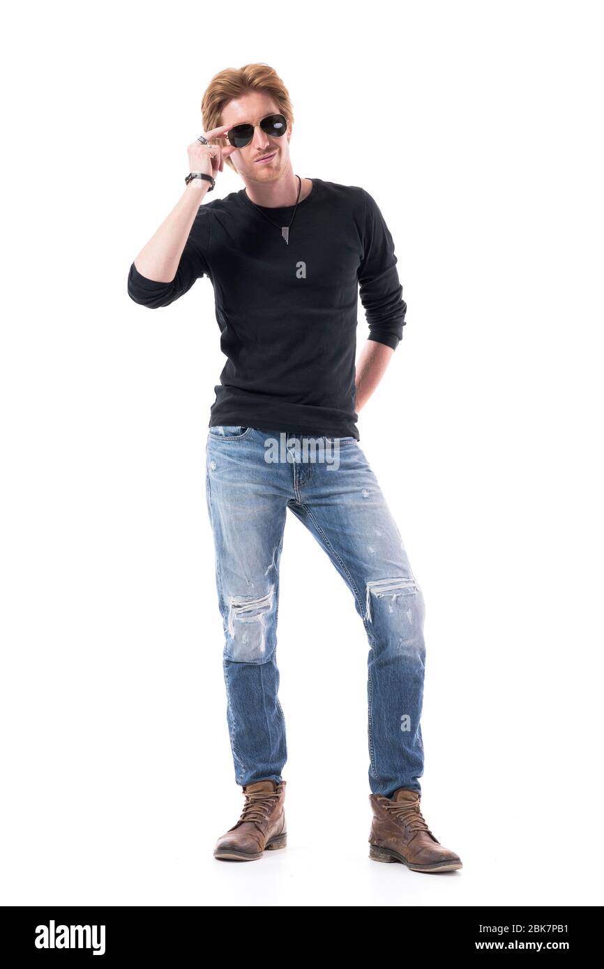 Handsome young ginger man looking away holding sunglasses with smirking ...