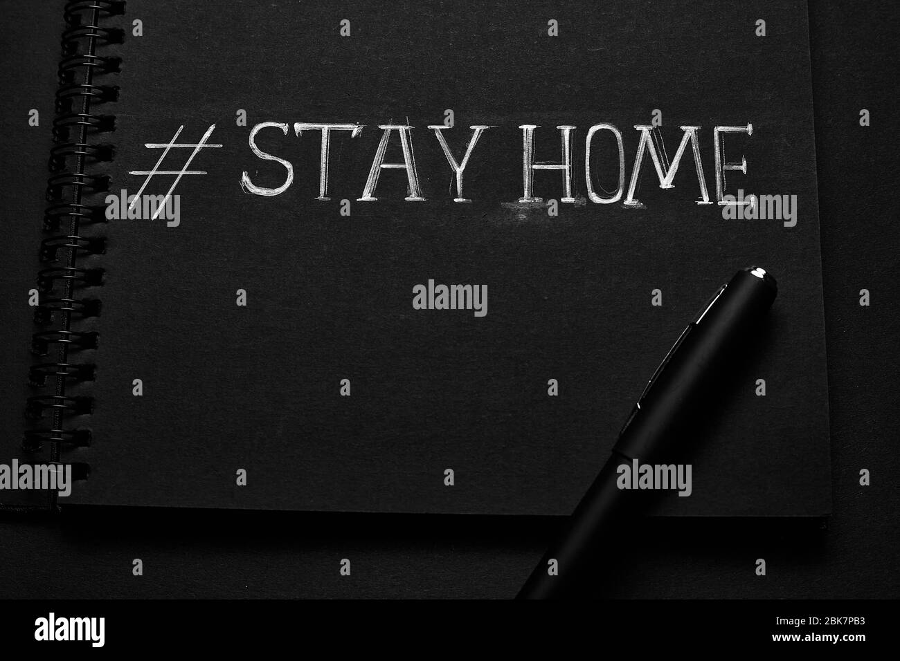 Stay at home, text. Headline inscription on black paper background ...