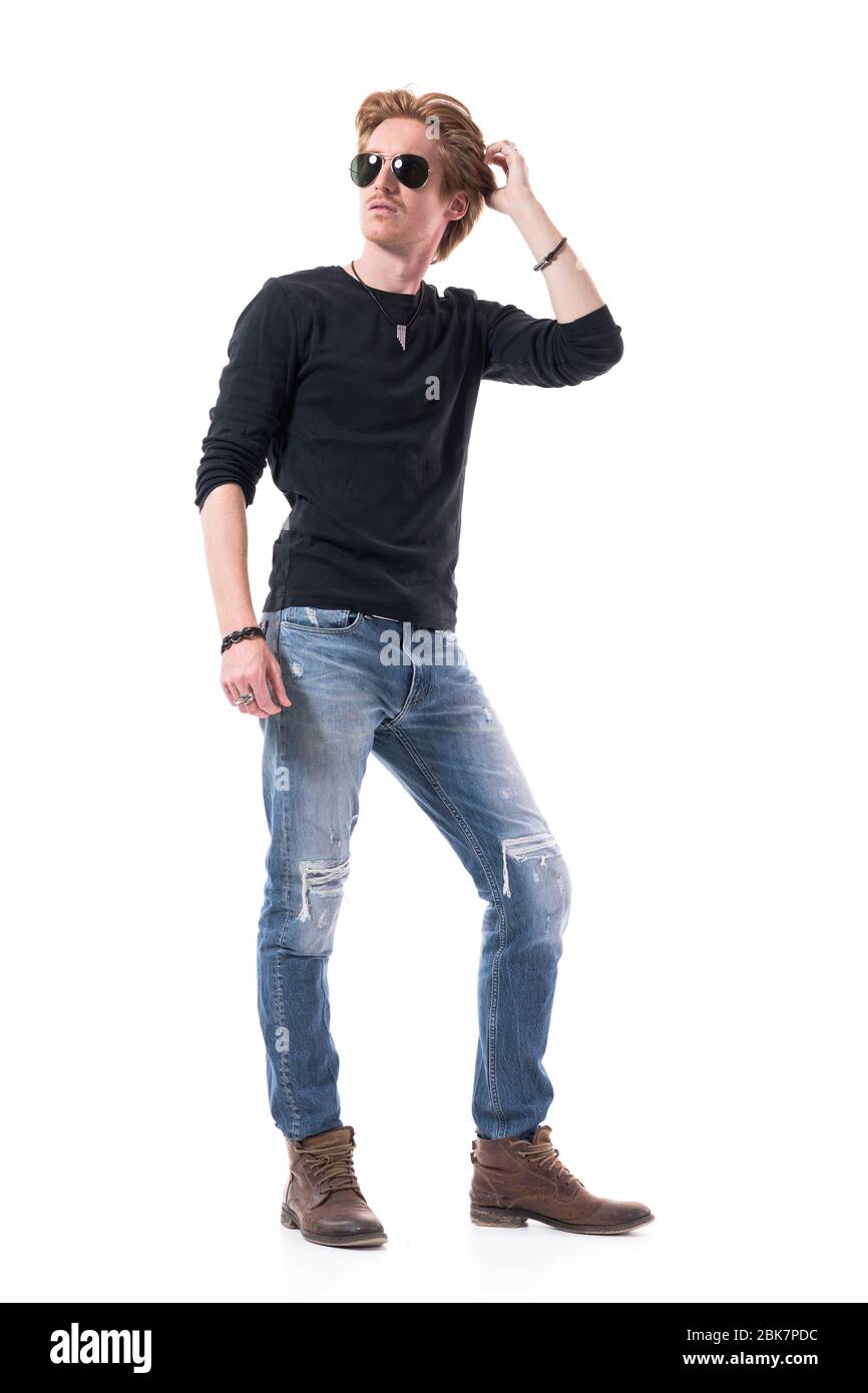 Handsome young red hair man with sunglasses turning back looking up ...