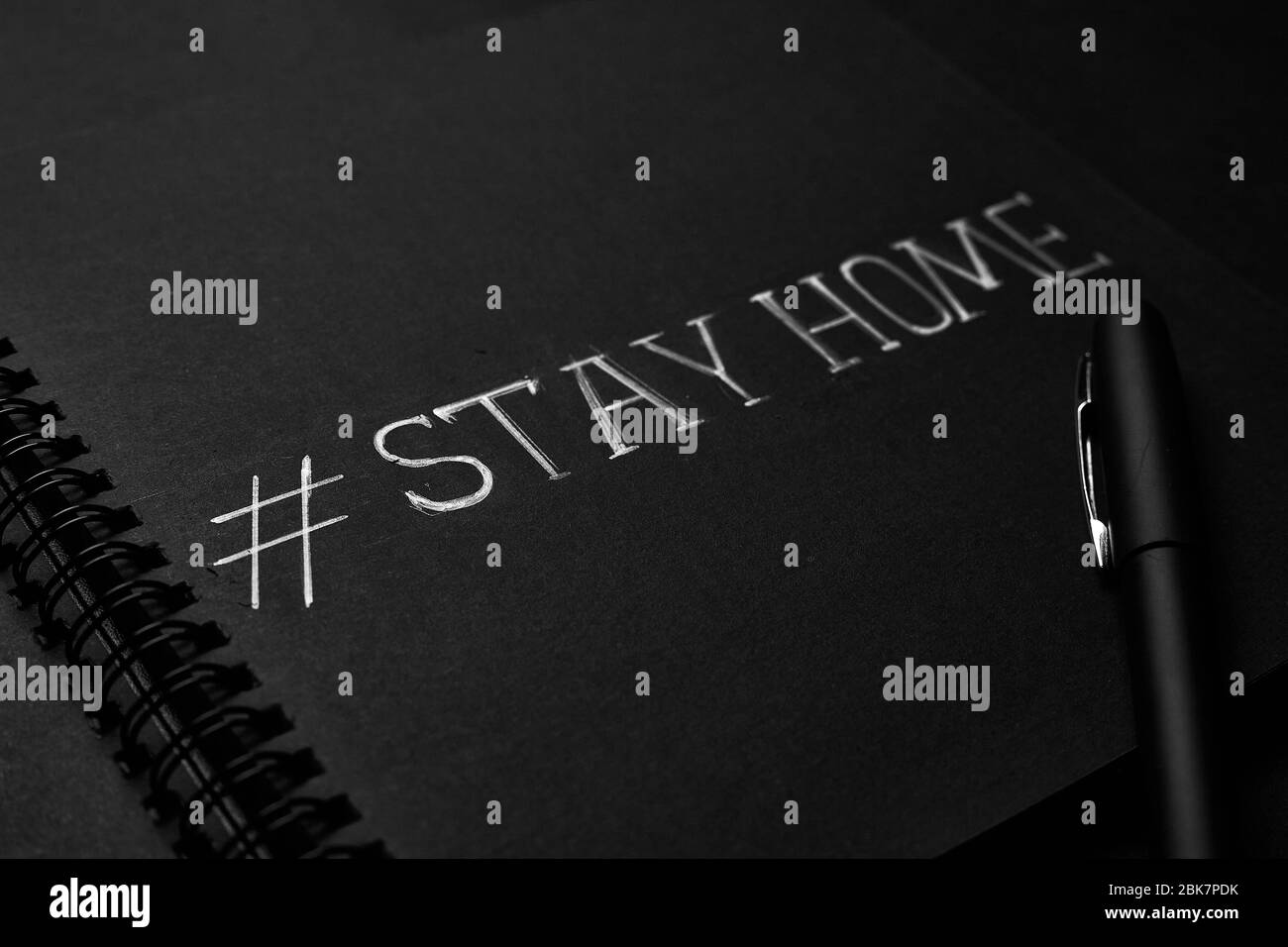 Stay at home, text. Headline inscription on black paper background ...