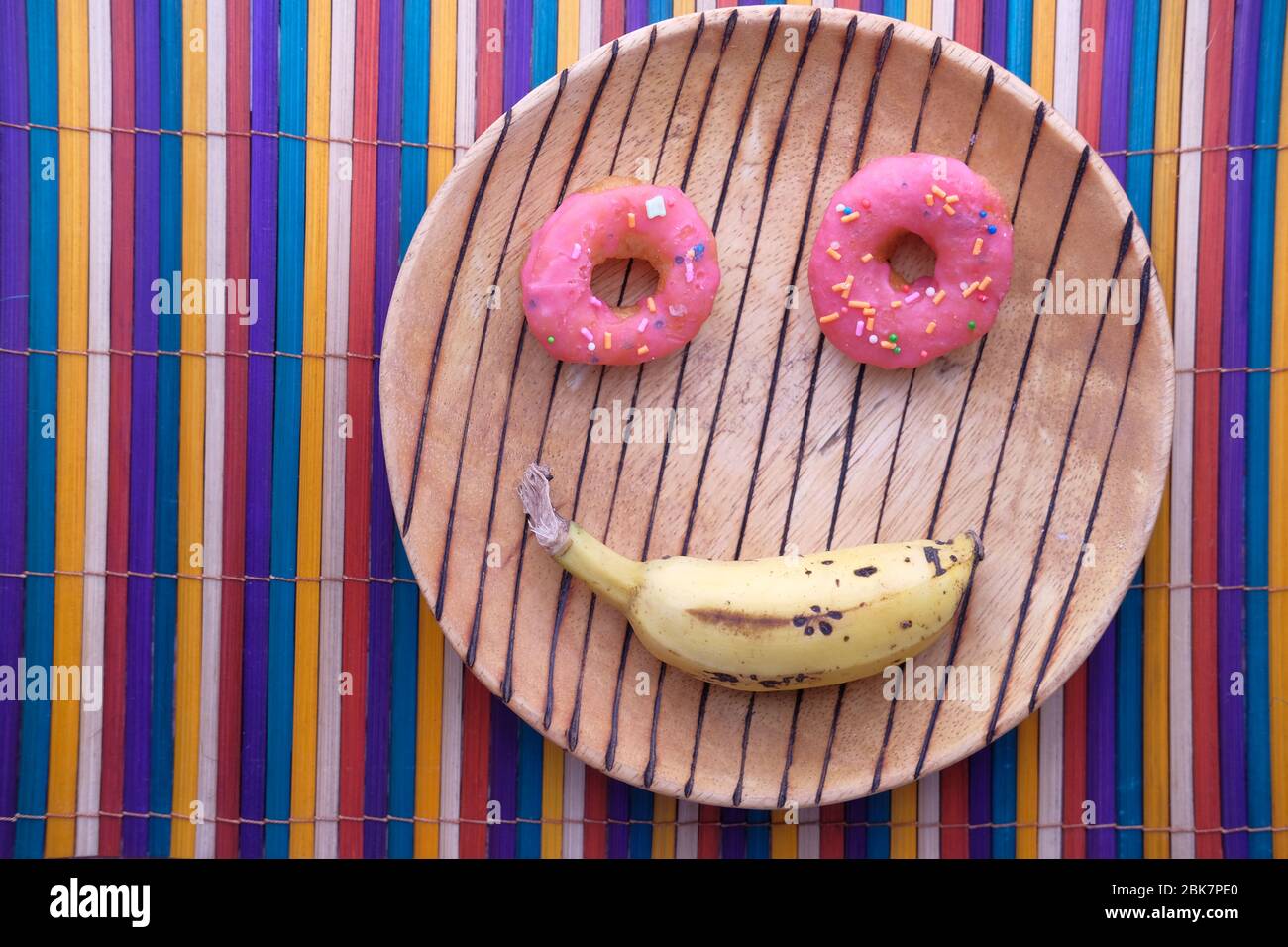 Funny smiling face donut on plate Stock Photo - Alamy