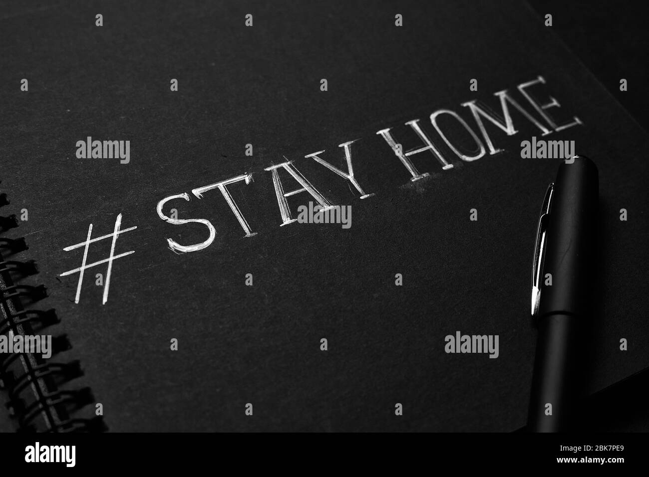 Stay at home, text. Headline inscription on black paper background ...