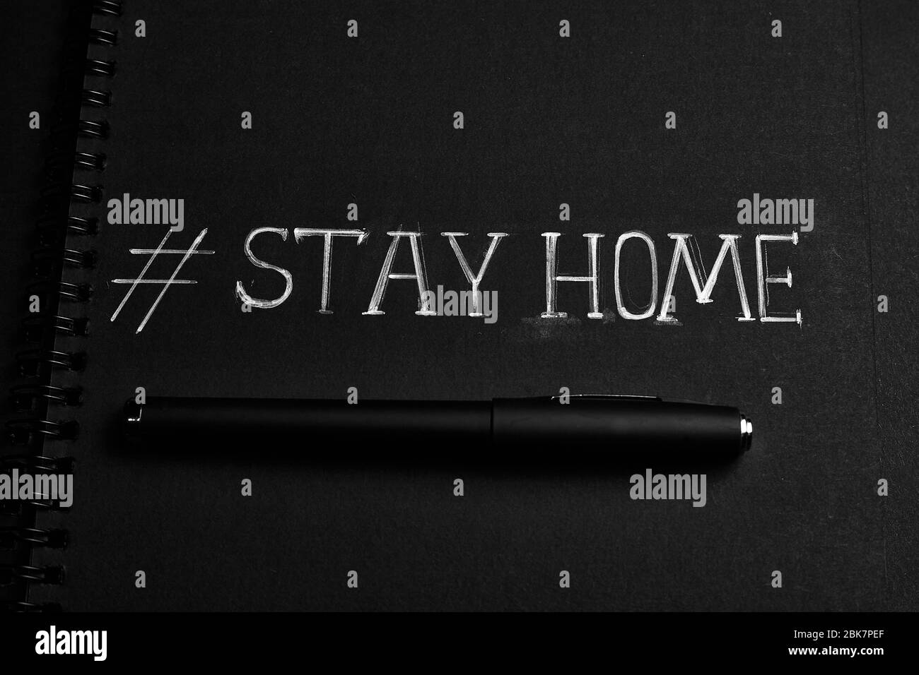 Stay at home, text. Headline inscription on black paper background ...