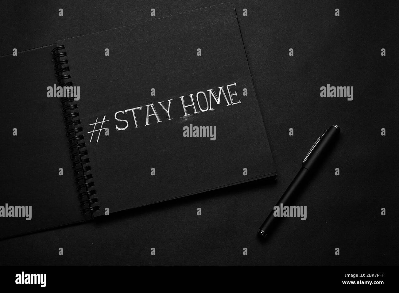 Stay at home, text. Headline inscription on black paper background ...