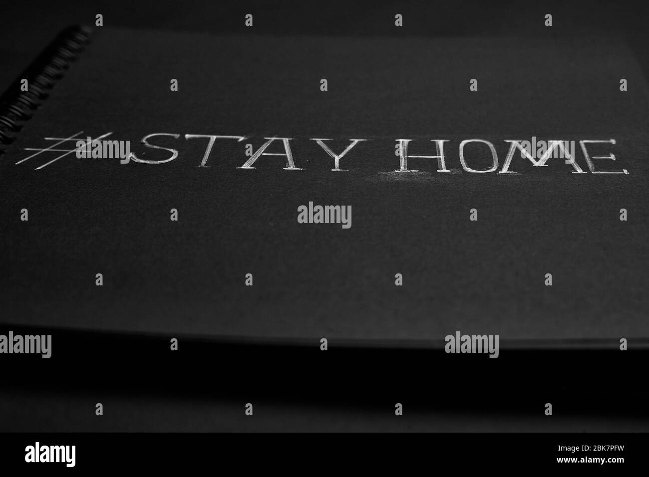 Stay at home, text. Headline inscription on black paper background ...