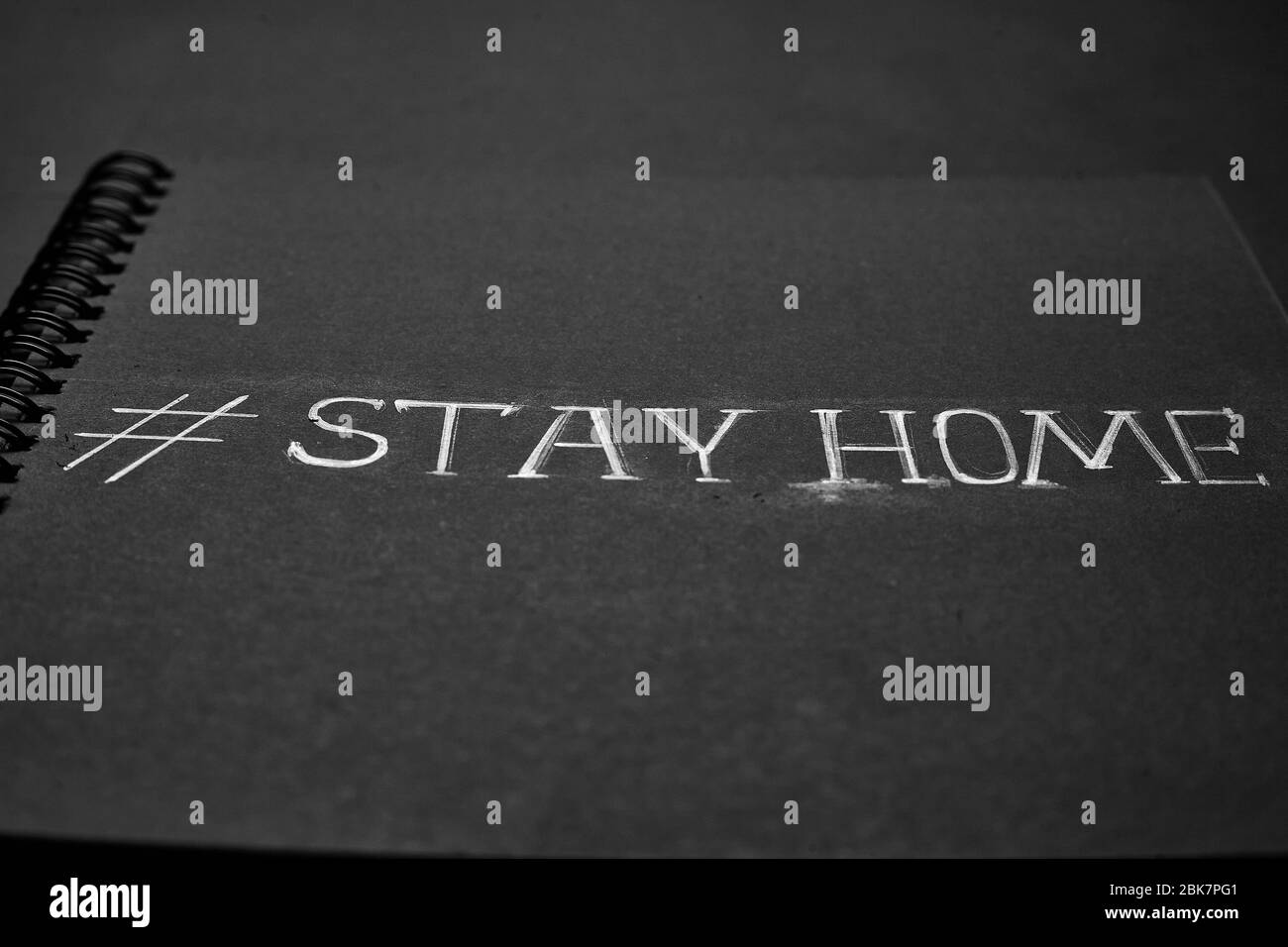 Stay at home, text. Headline inscription on black paper background ...