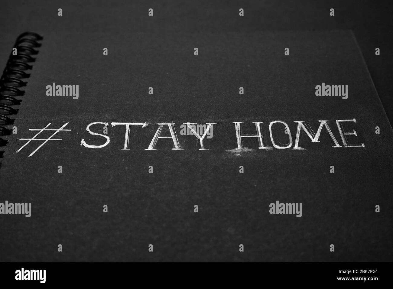 Stay at home, text. Headline inscription on black paper background ...