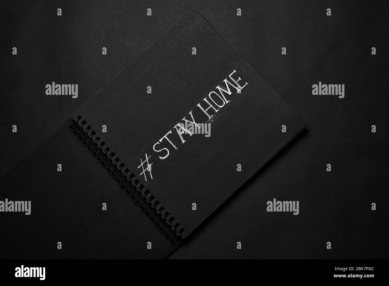 Stay at home, text. Headline inscription on black paper background ...