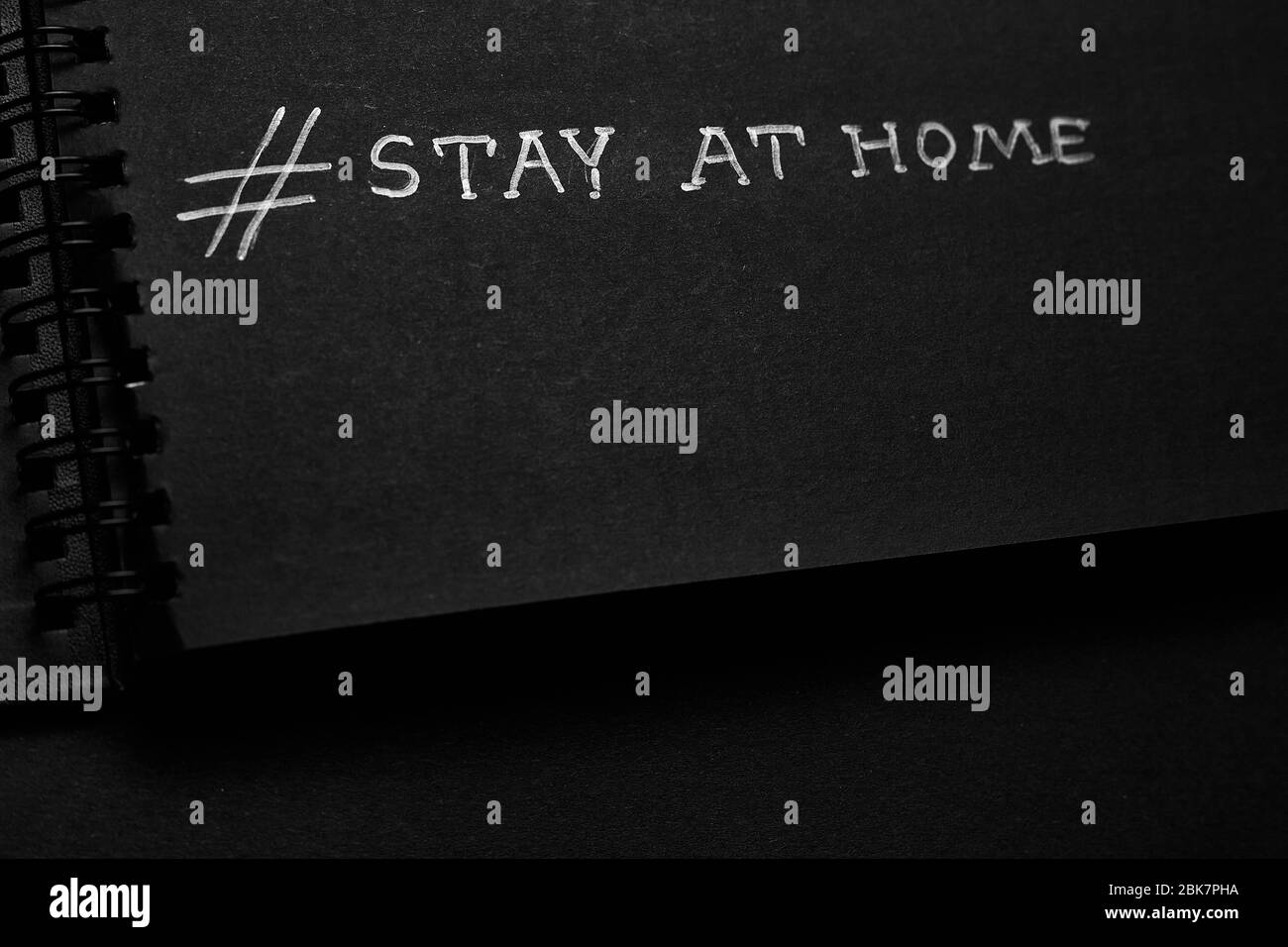 Stay at home, text. Headline inscription on black paper background ...
