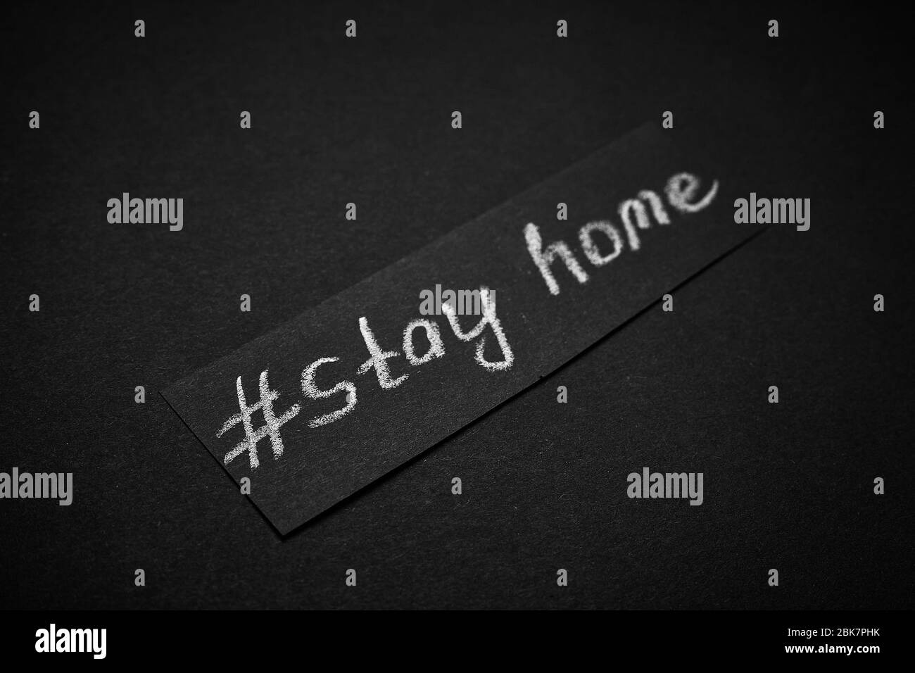 Stay at home, text. Headline inscription on black paper background ...