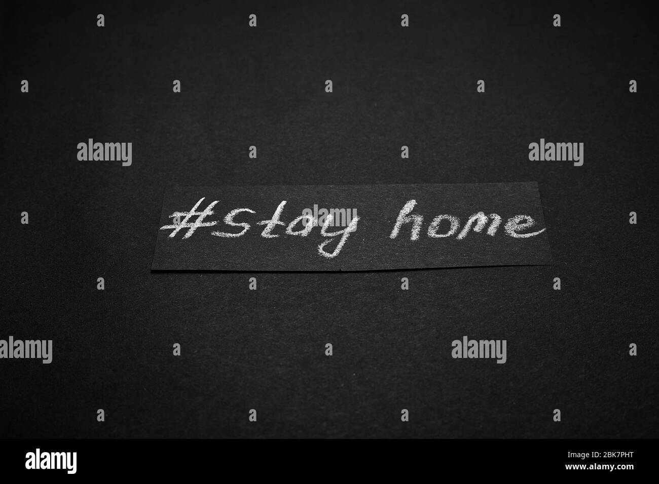 Stay at home, text. Headline inscription on black paper background ...