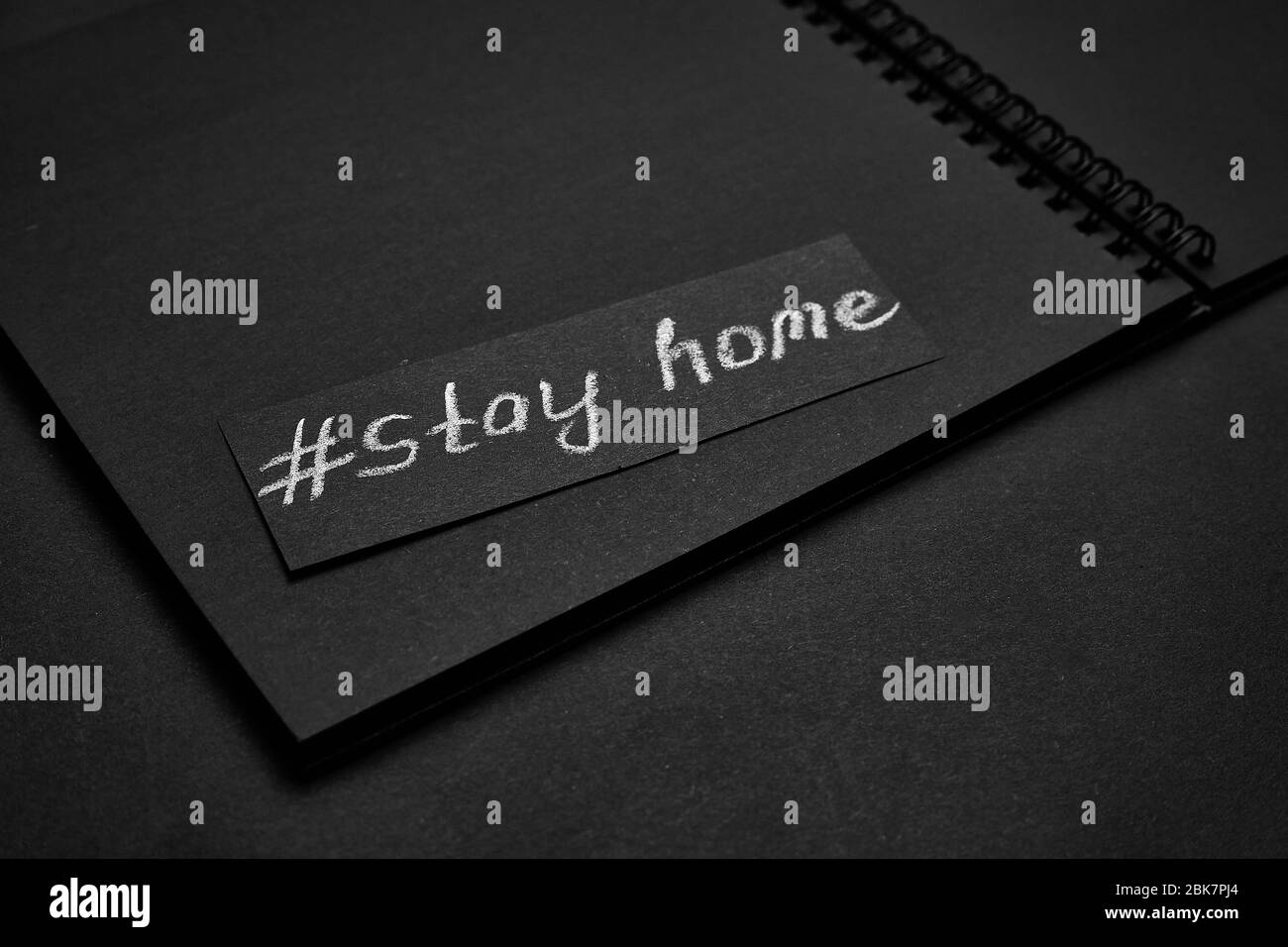Stay at home, text. Headline inscription on black paper background ...