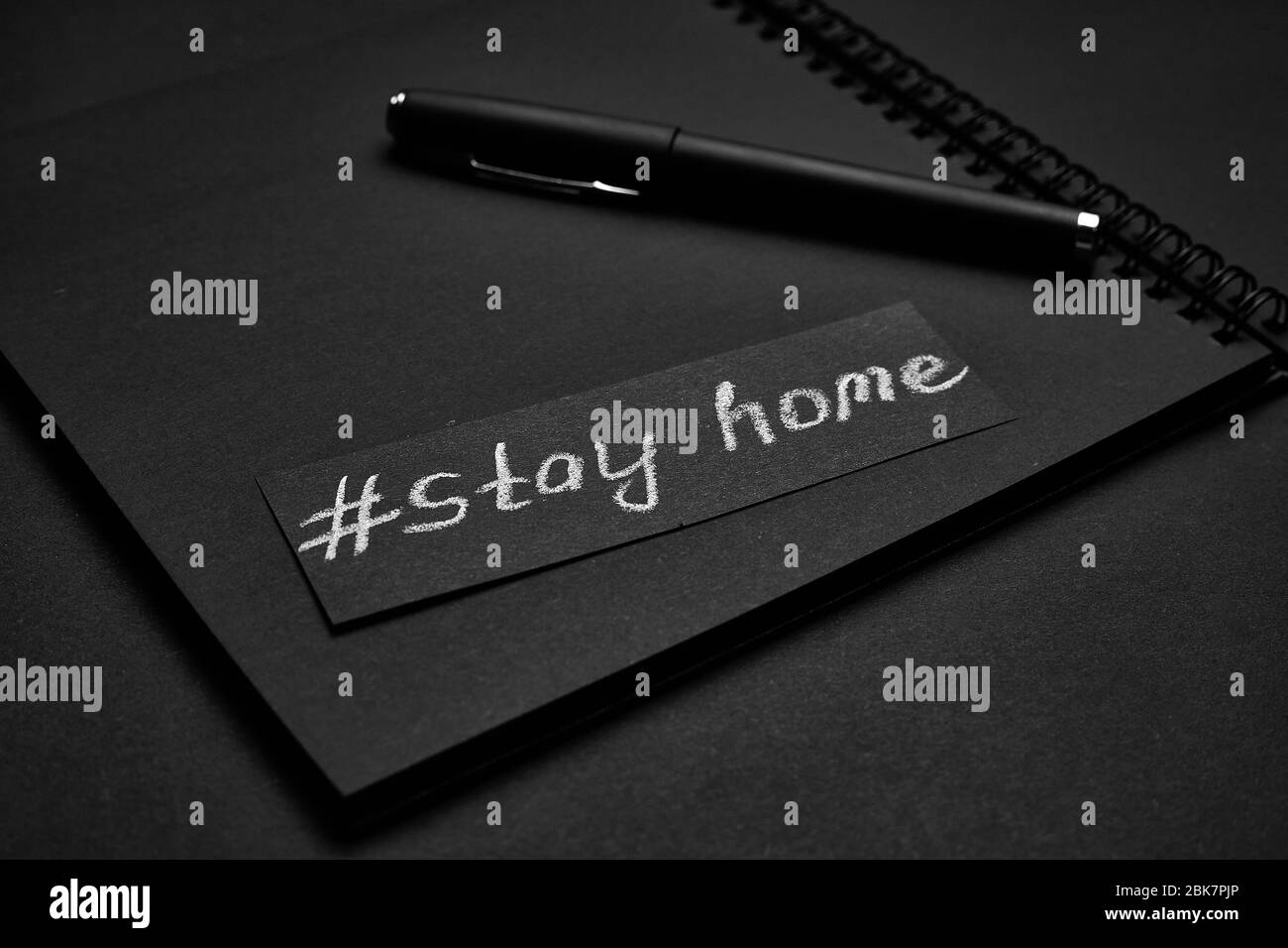 Stay at home, text. Headline inscription on black paper background ...