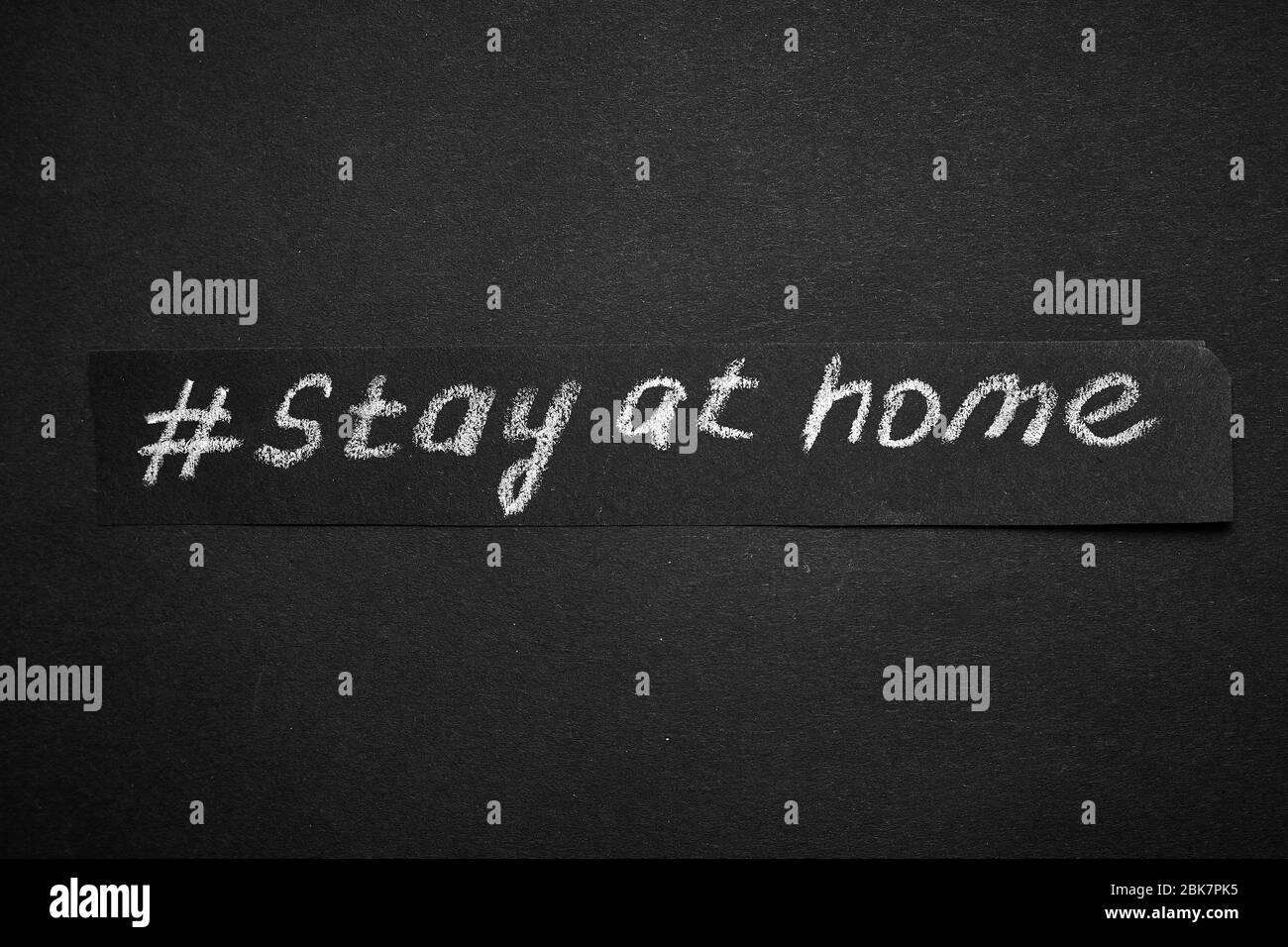 Stay at home, text. Headline inscription on black paper background ...
