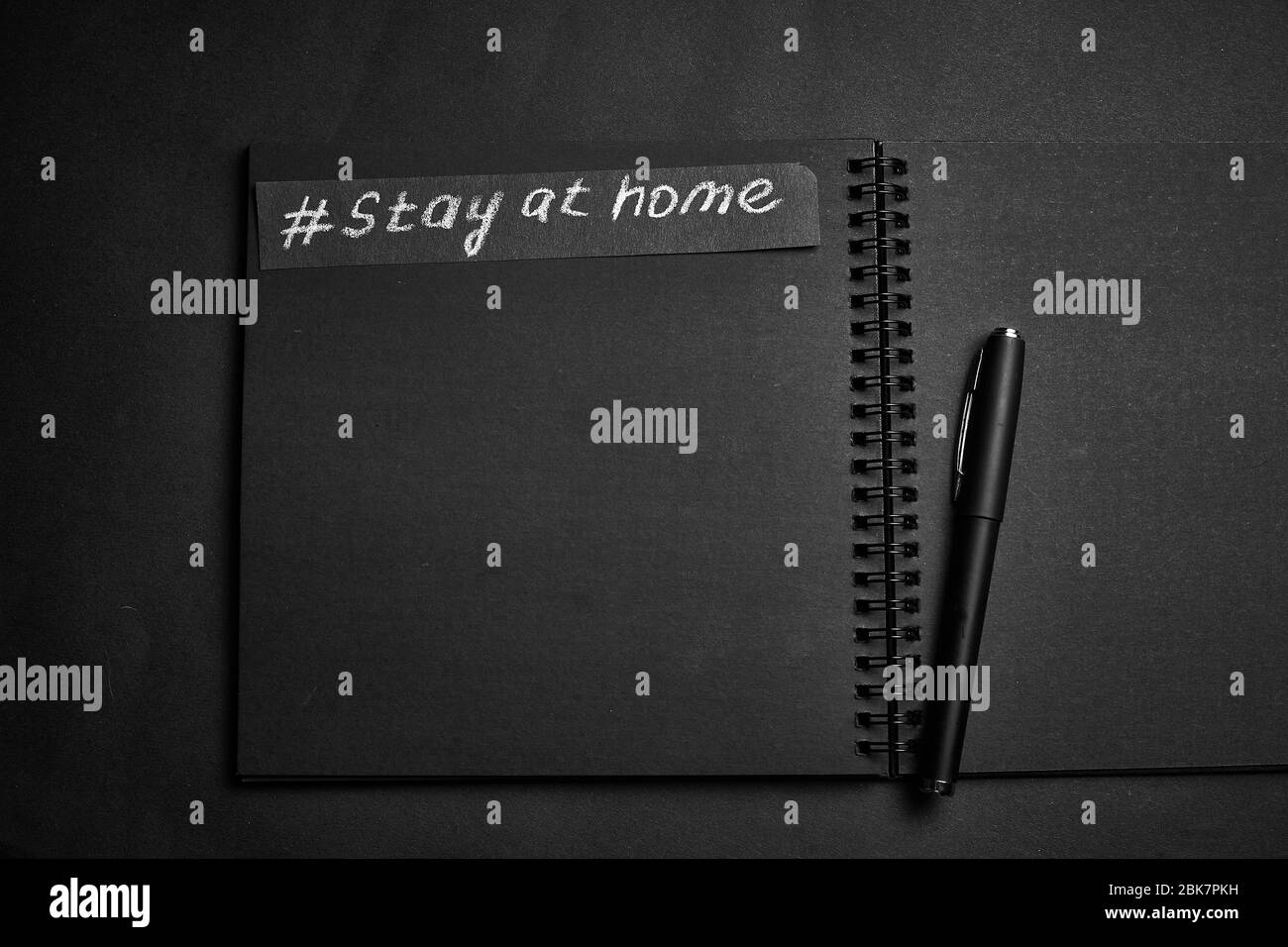 Stay at home, text. Headline inscription on black paper background ...
