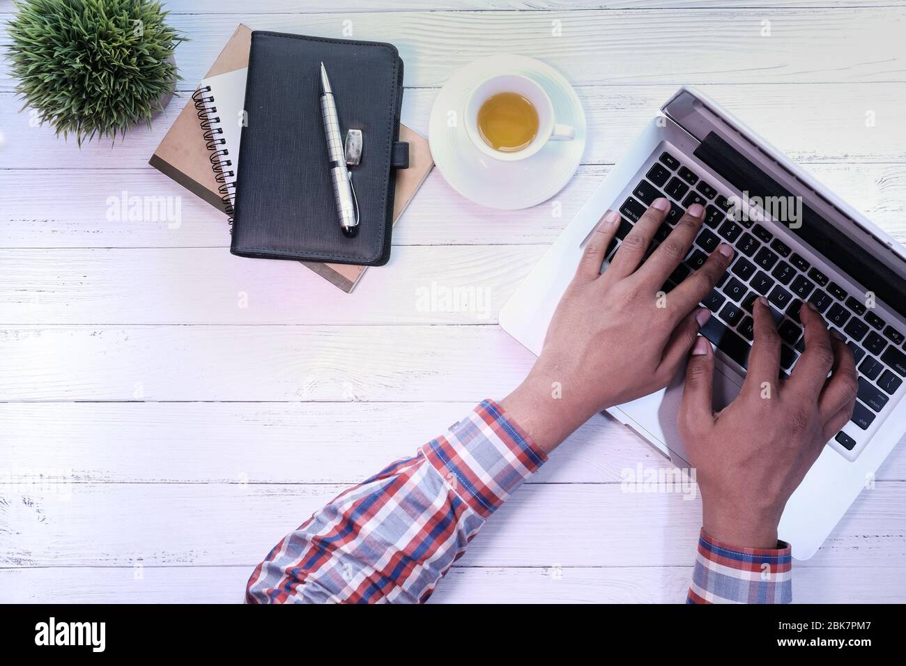 young man typing on laptop keyboard in office Stock Photo - Alamy