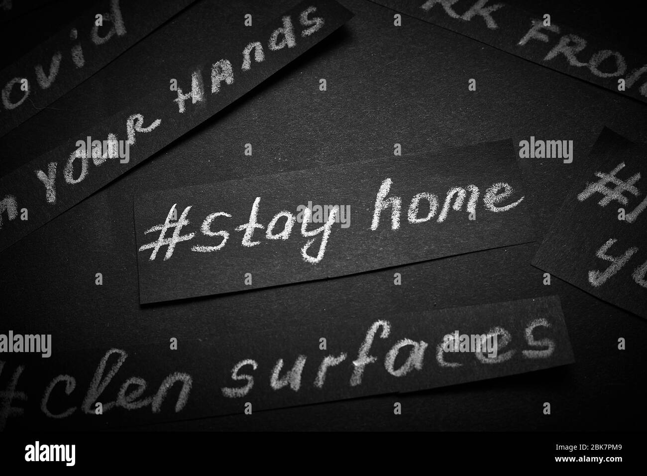 Stay at home, text. Headline inscription on black paper background ...