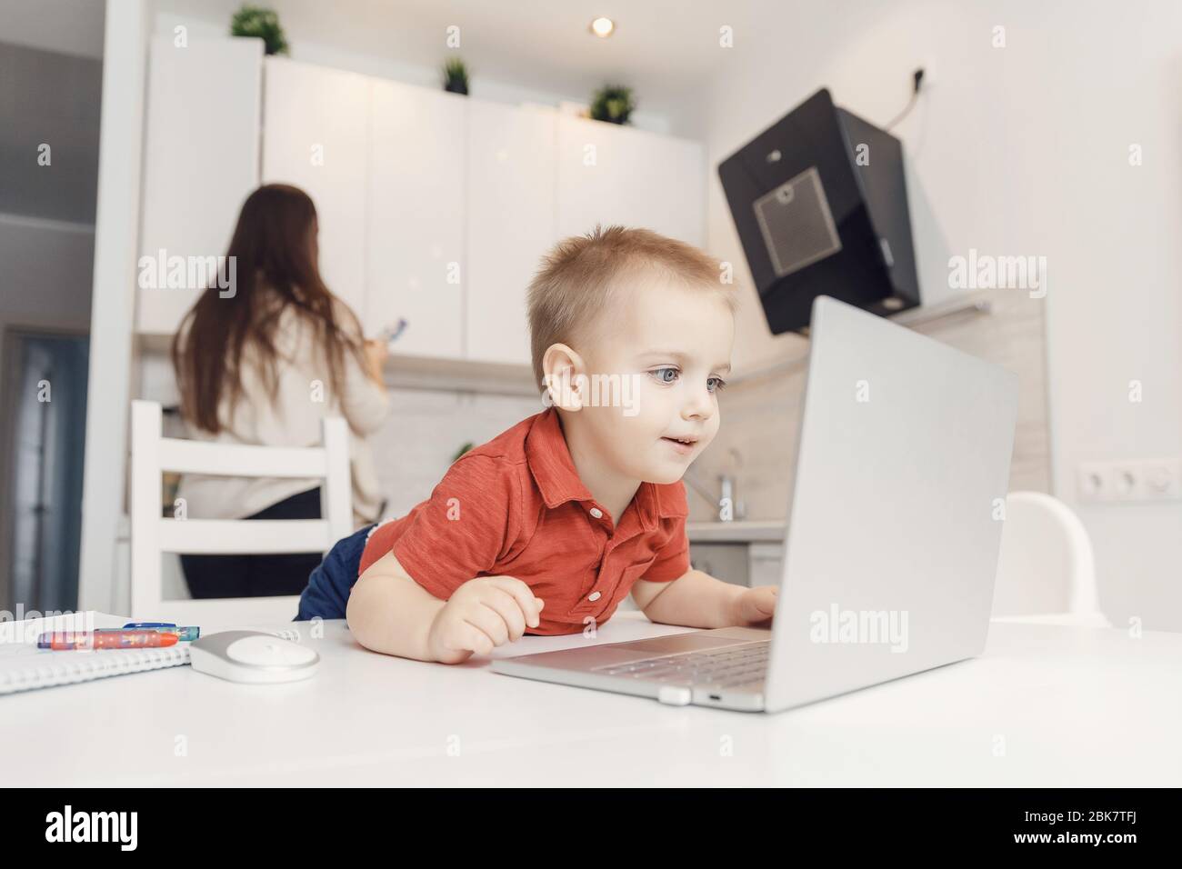 Boy child enthusiastically watching video blog or cartoons on laptop ...