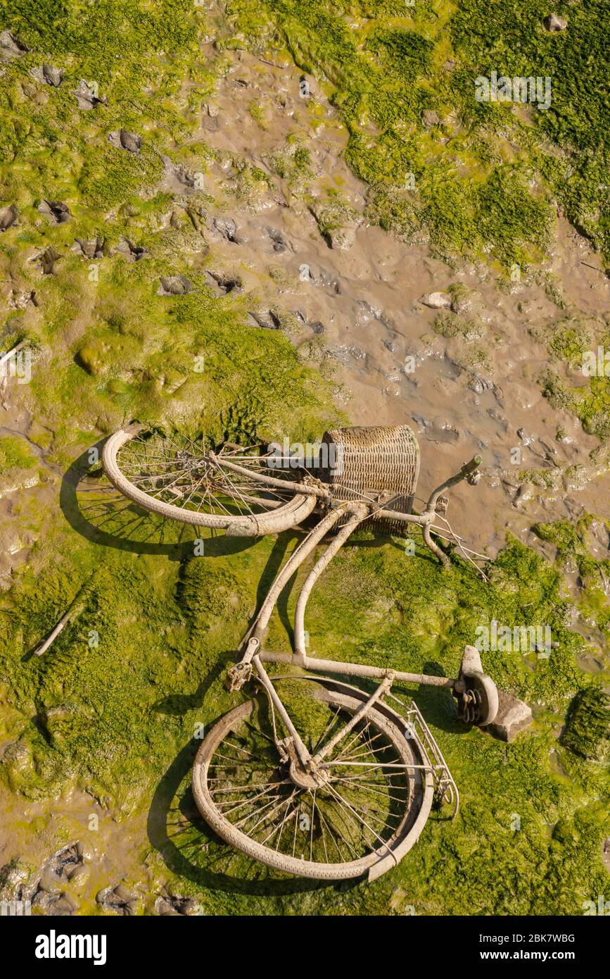 A discarded bicycle with a wicker basket to the canal, a typical ...