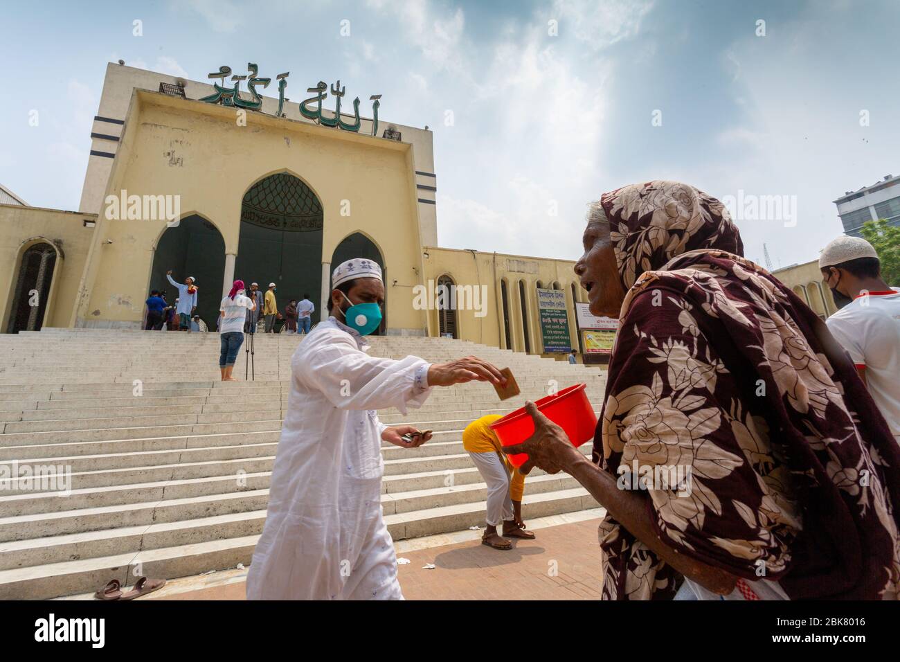 Bangladesh – April 03, 2020: A Muslim is giving money to a poor ...