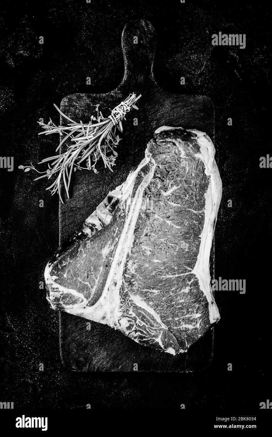 Dry Aged Premium Raw T-bone Steak on Rustic Kitchen Chopping Board ...