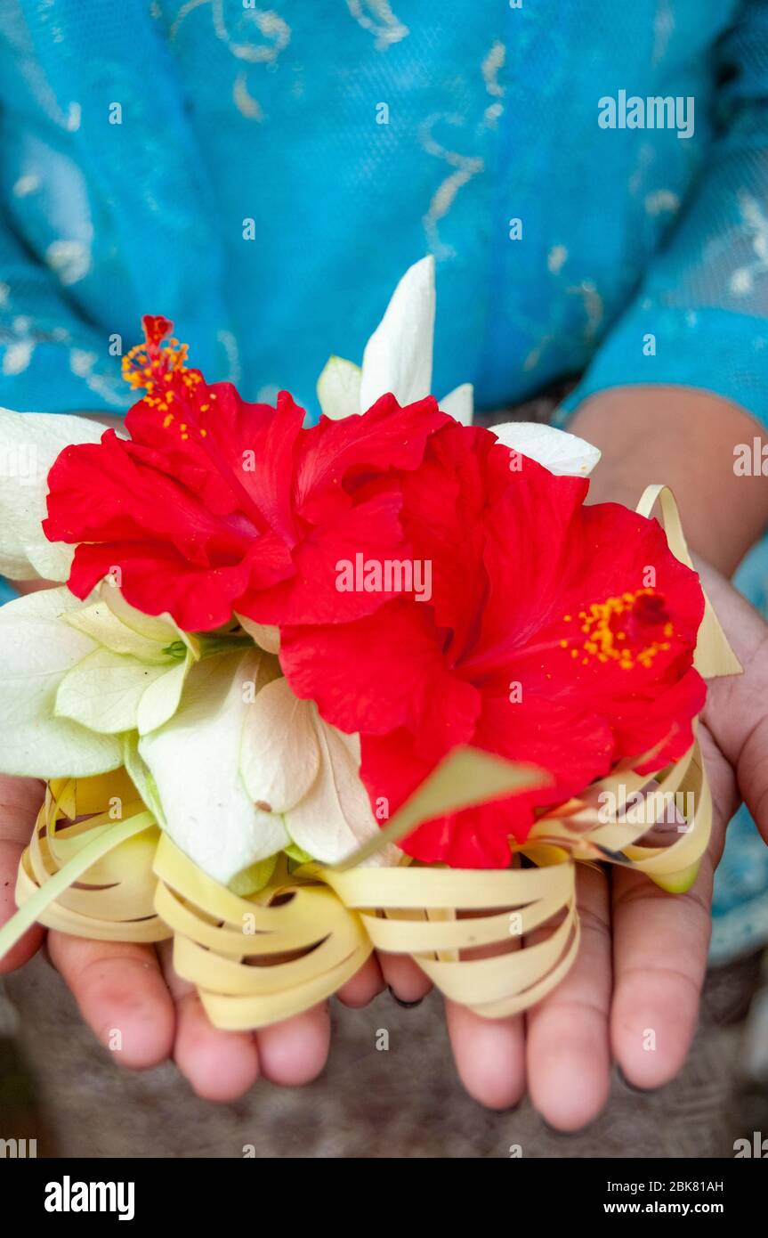 Young Balinese woman holding flower offering at Gunung Kawi temple and ...
