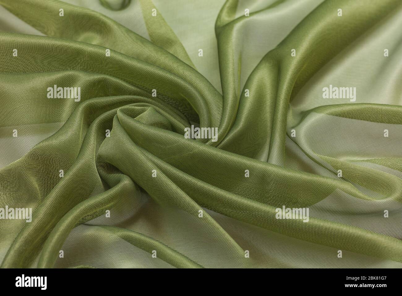 Creased beige curved cloth material fragment with swirl as fabric ...