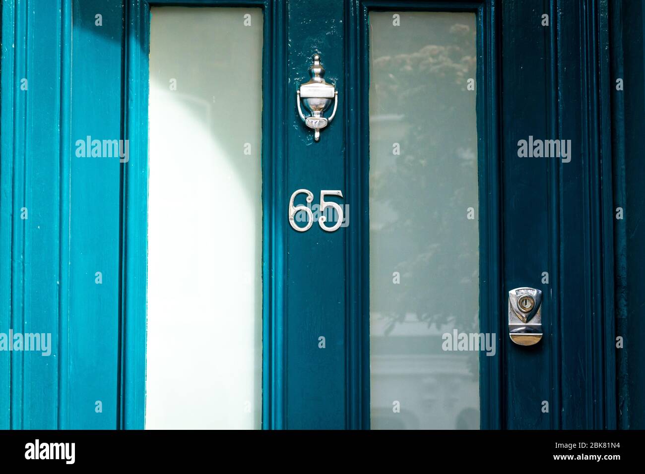House number 65 in silver on blue Stock Photo - Alamy