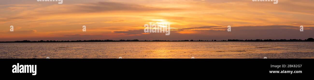 Peaceful summer landscape with beautiful sunset on the quiet lake, the ...