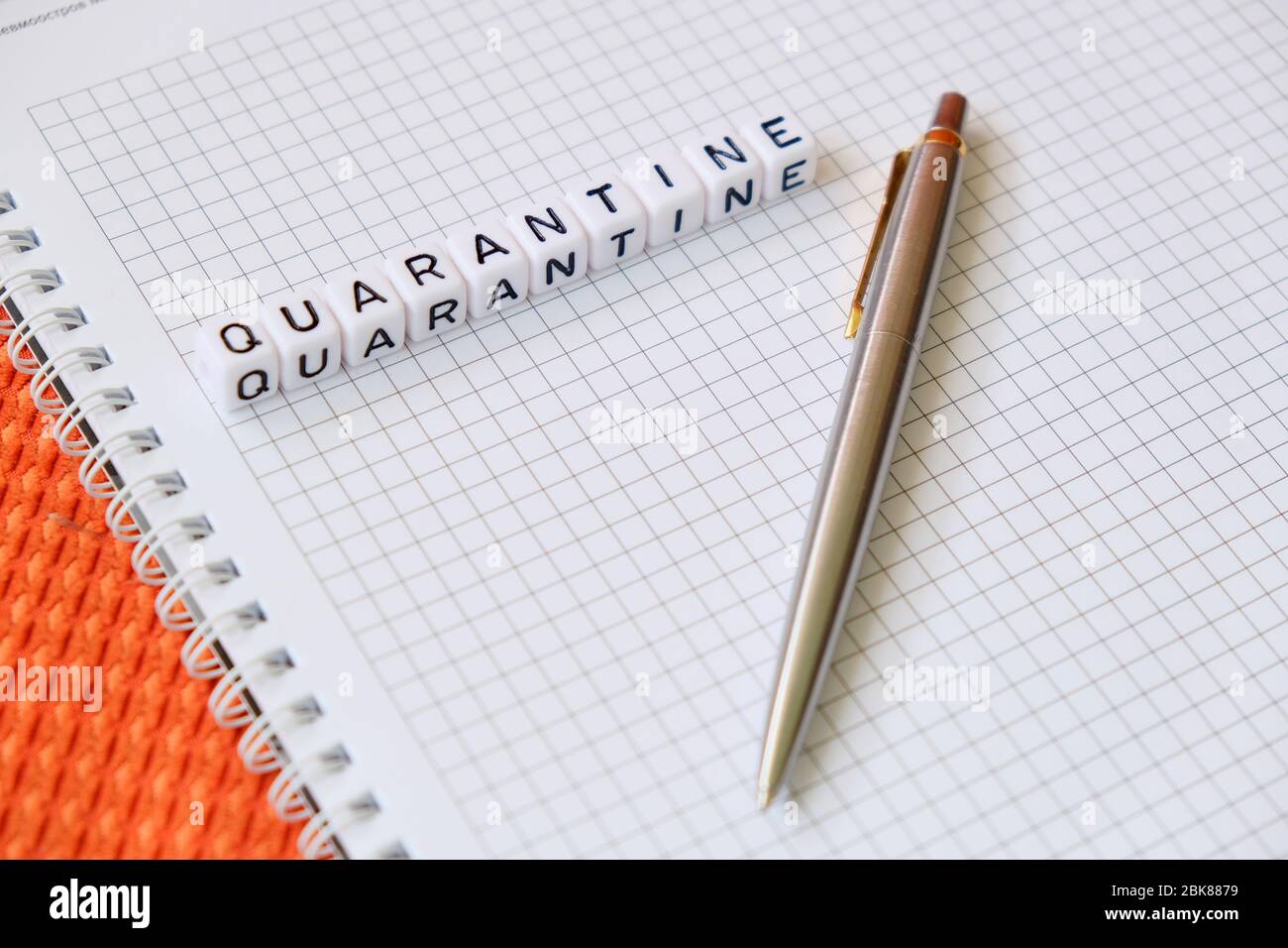 Text Quarantine , word made of cubic letters and luxury pen on a white ...