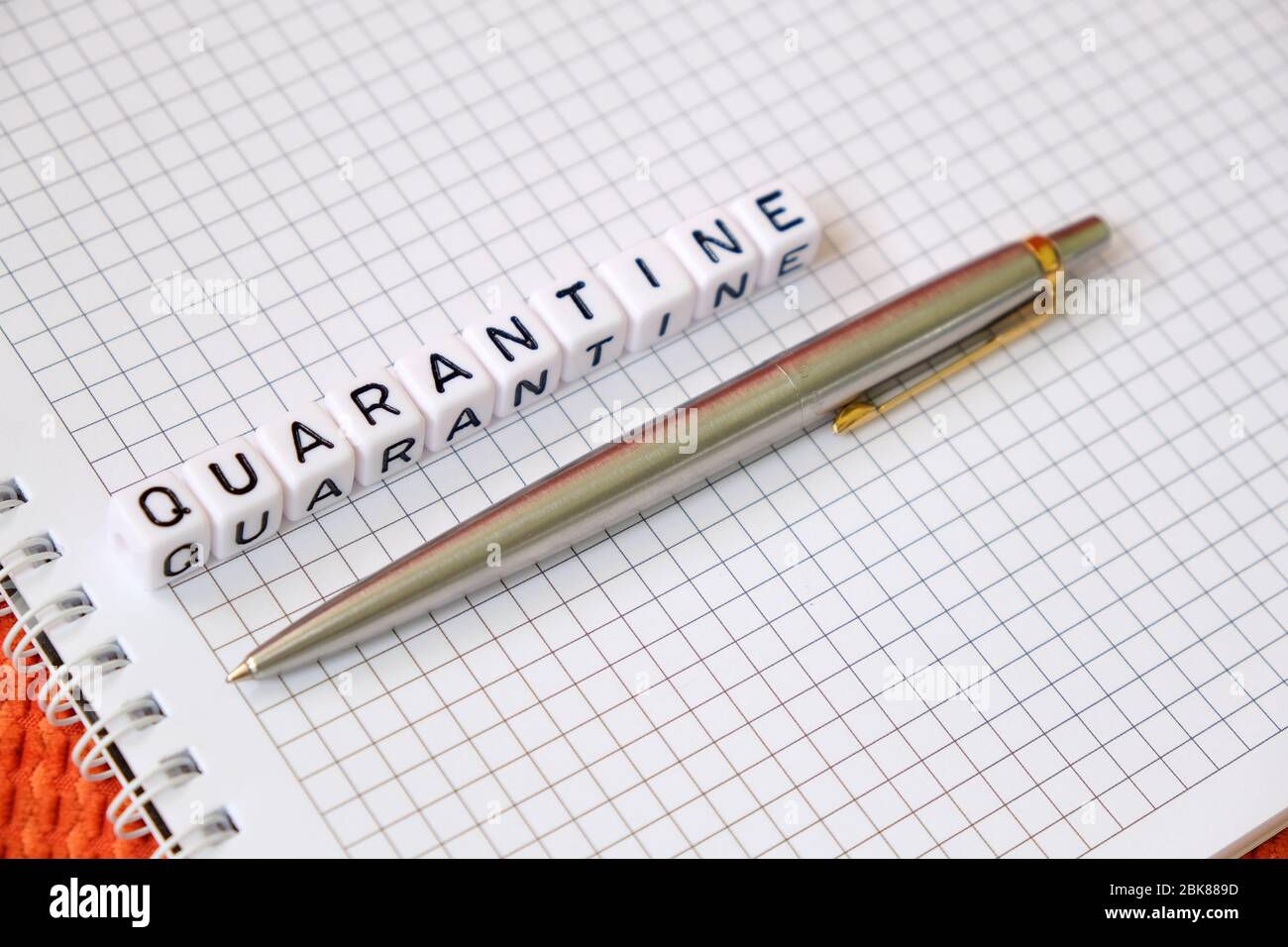 Text Quarantine , word made of cubic letters and luxury pen on a white ...