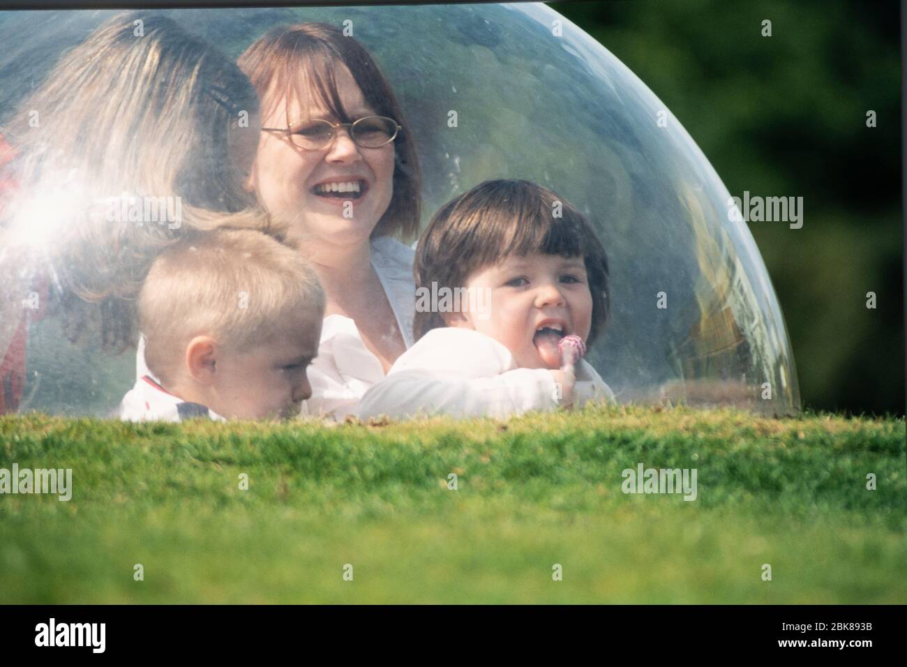 A family of of adults and children inside a glass dome observing ...