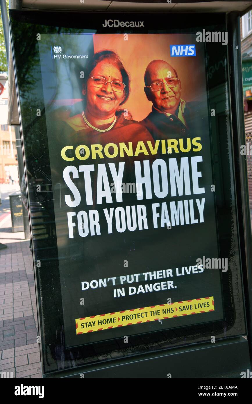 Poster at a bus stop telling commuters to stay at home and not travel ...