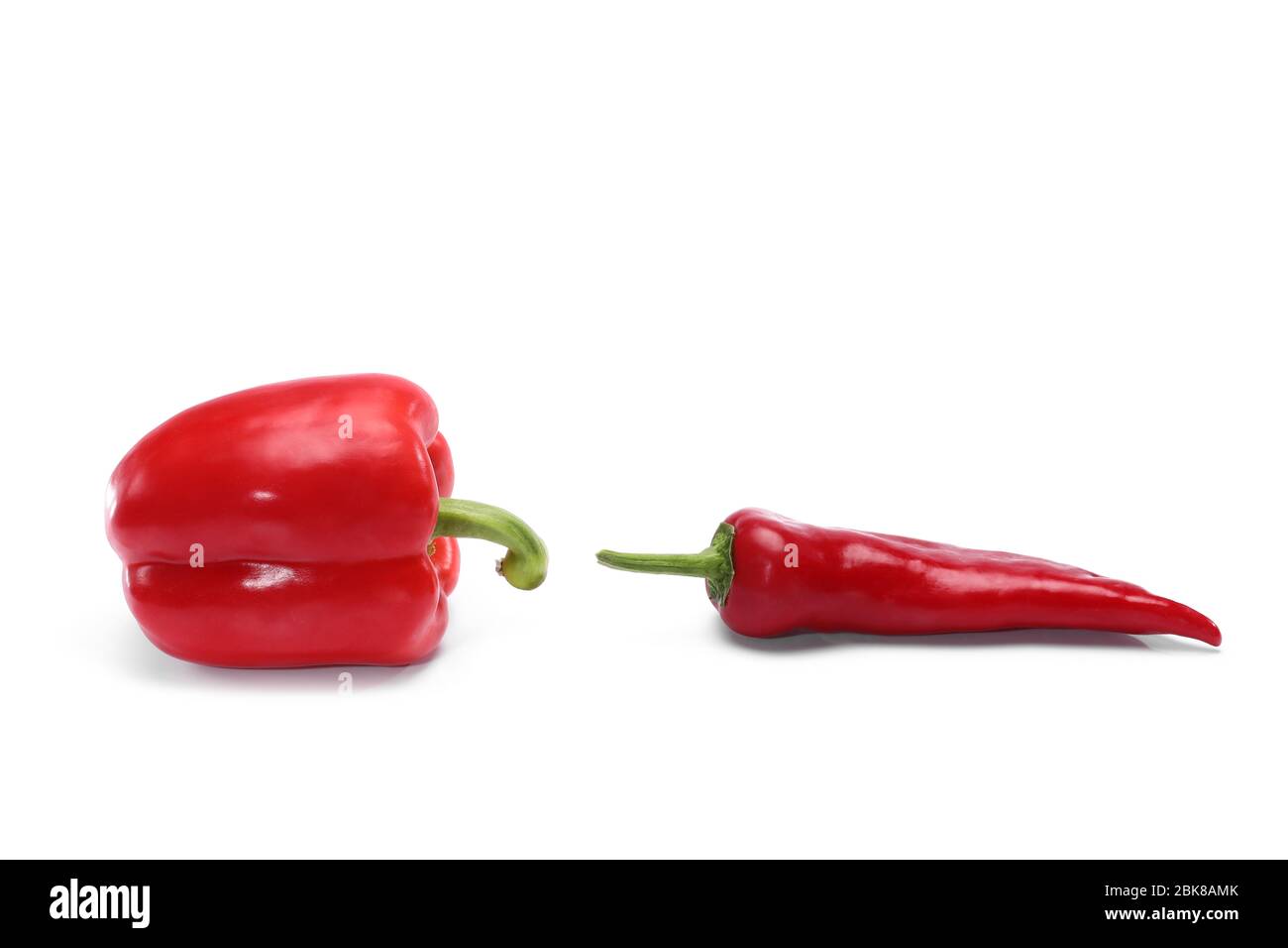 two Different types of fresh red peppers isolated on a white background ...