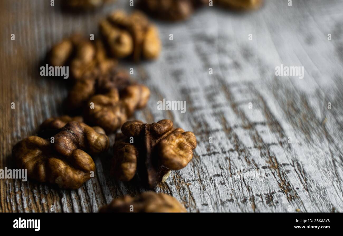 Walnut scattered on the wooden vintage table. Walnuts is a healthy ...