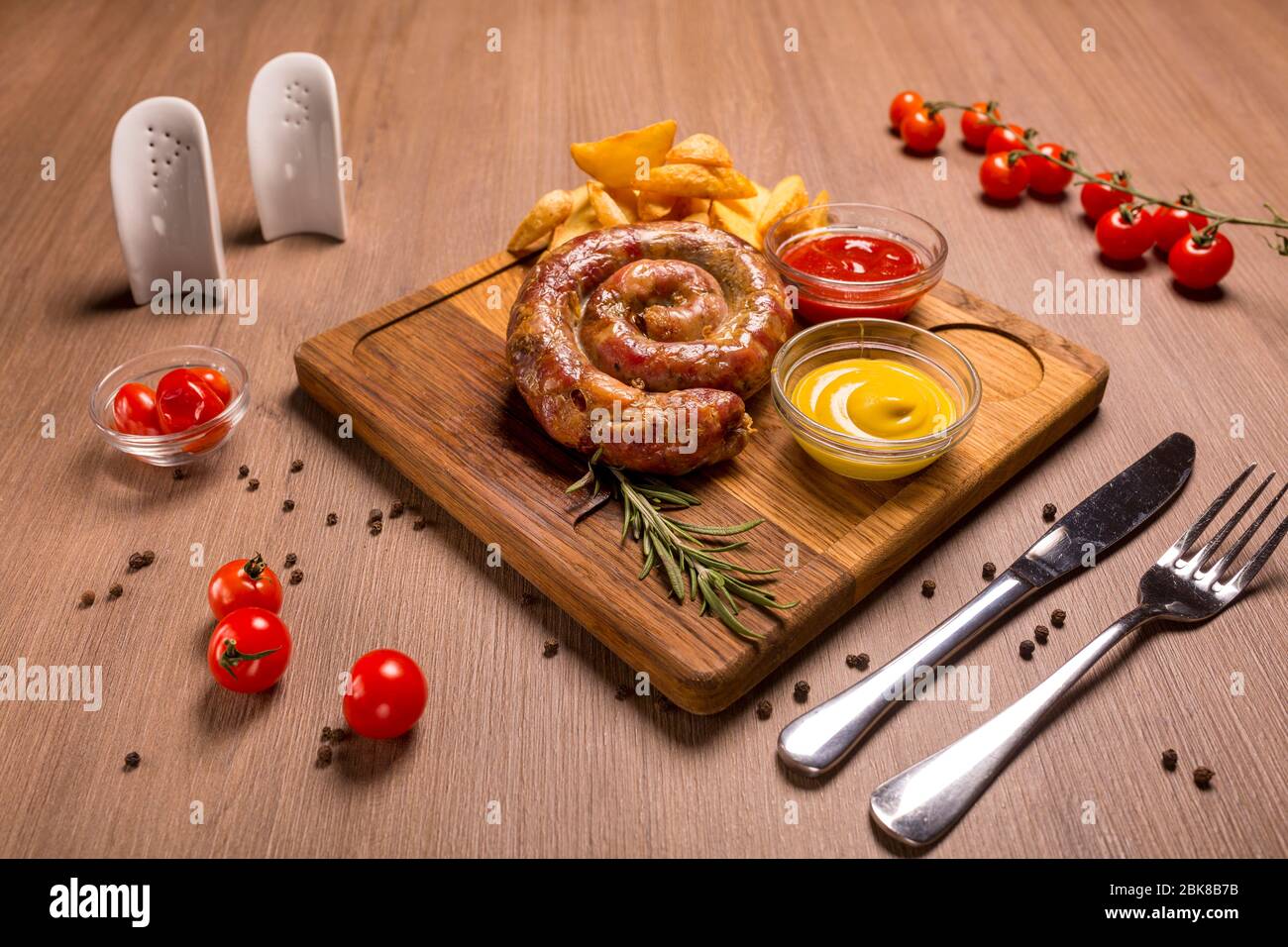 Grilled sausages with french fries with ketchup sauce and mustard on a ...