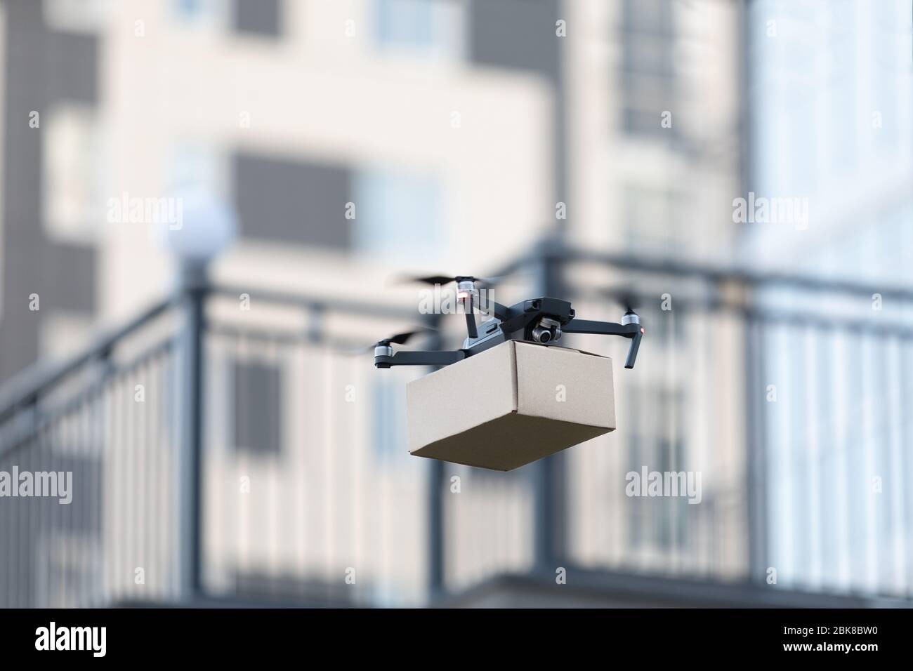 New smart drone with parcel, package delivery robot Stock Photo - Alamy