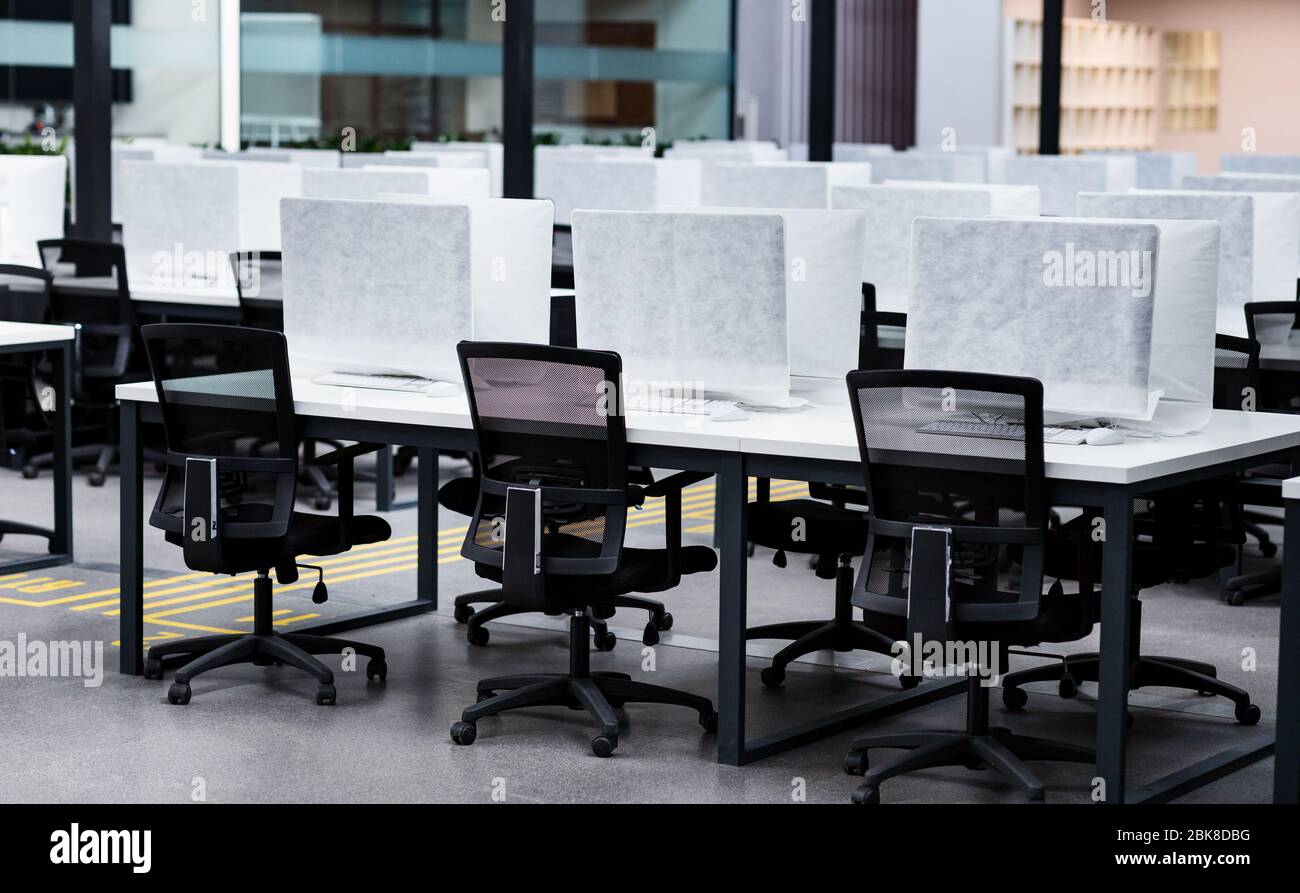 Photo of a computers wrapped in cover, empty coworking Stock Photo - Alamy