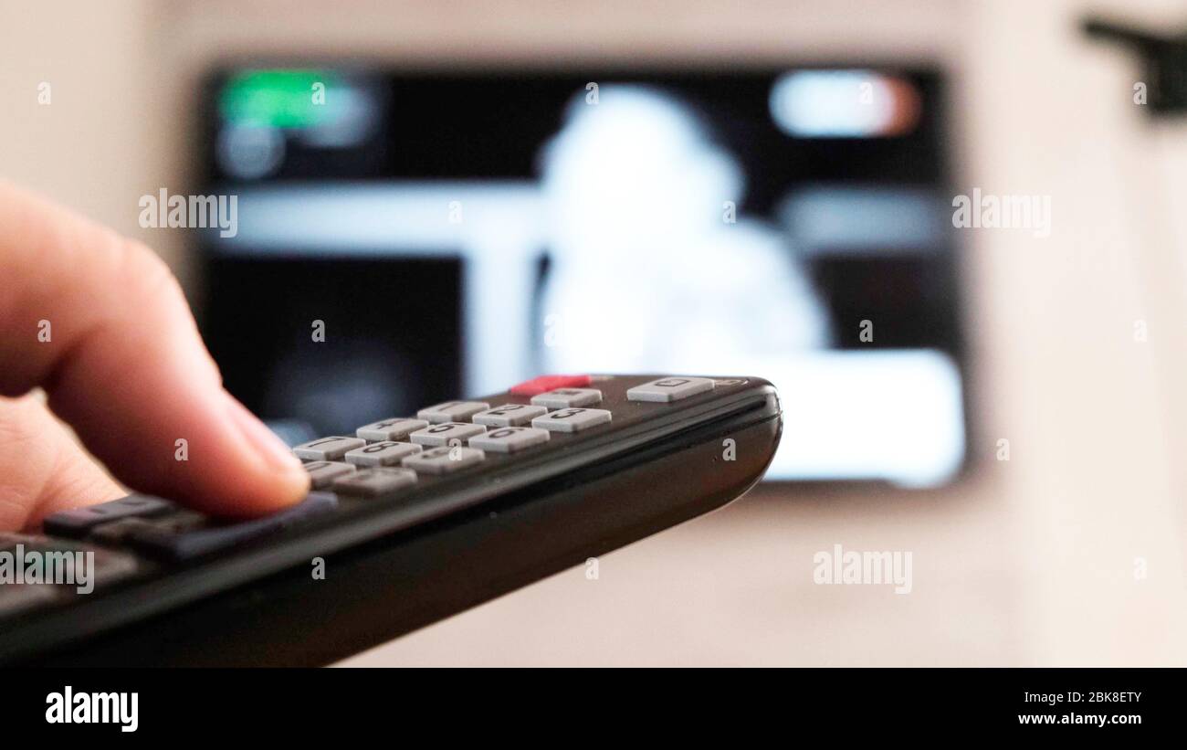 Hand holding remote control hi-res stock photography and images - Alamy