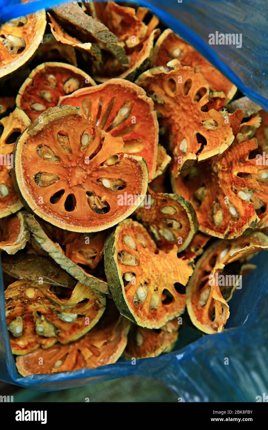 Pile quince (Aegle marmelos) or dried bale fruit tea in market. Bael ...