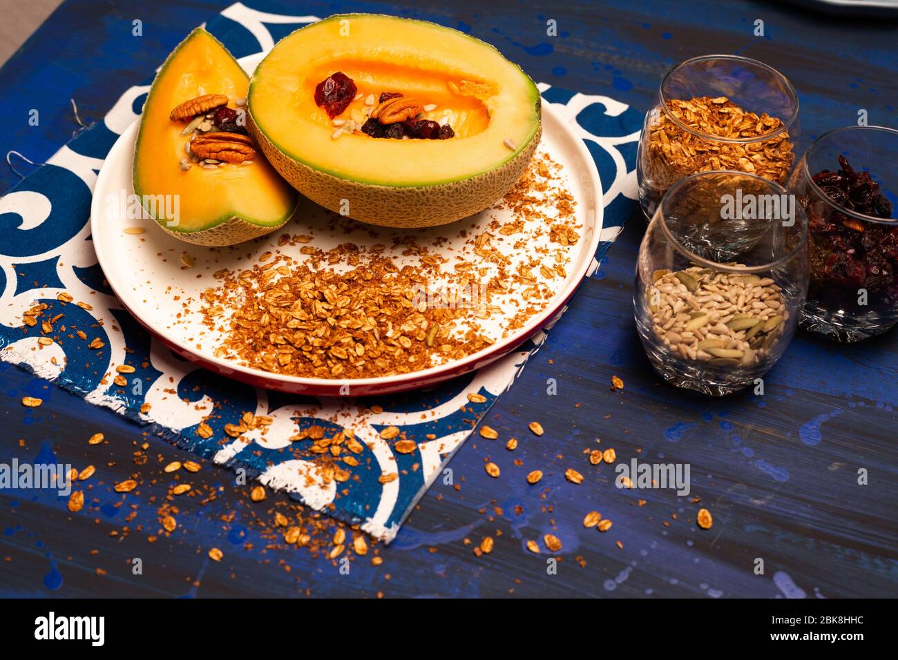 Melon pieces, on blue table with blue plate and seeds Stock Photo - Alamy