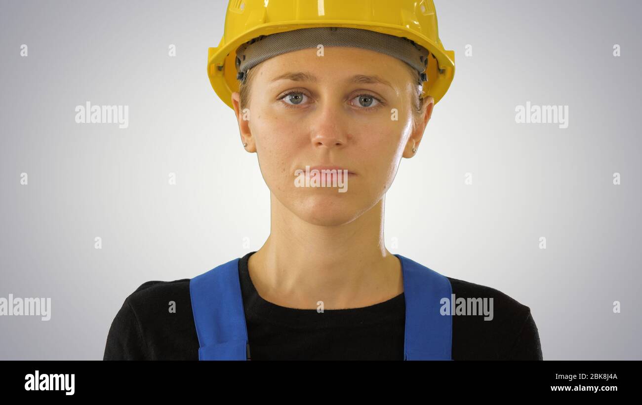 Young attractive caucasian woman builder in the hard yellow helmet on ...