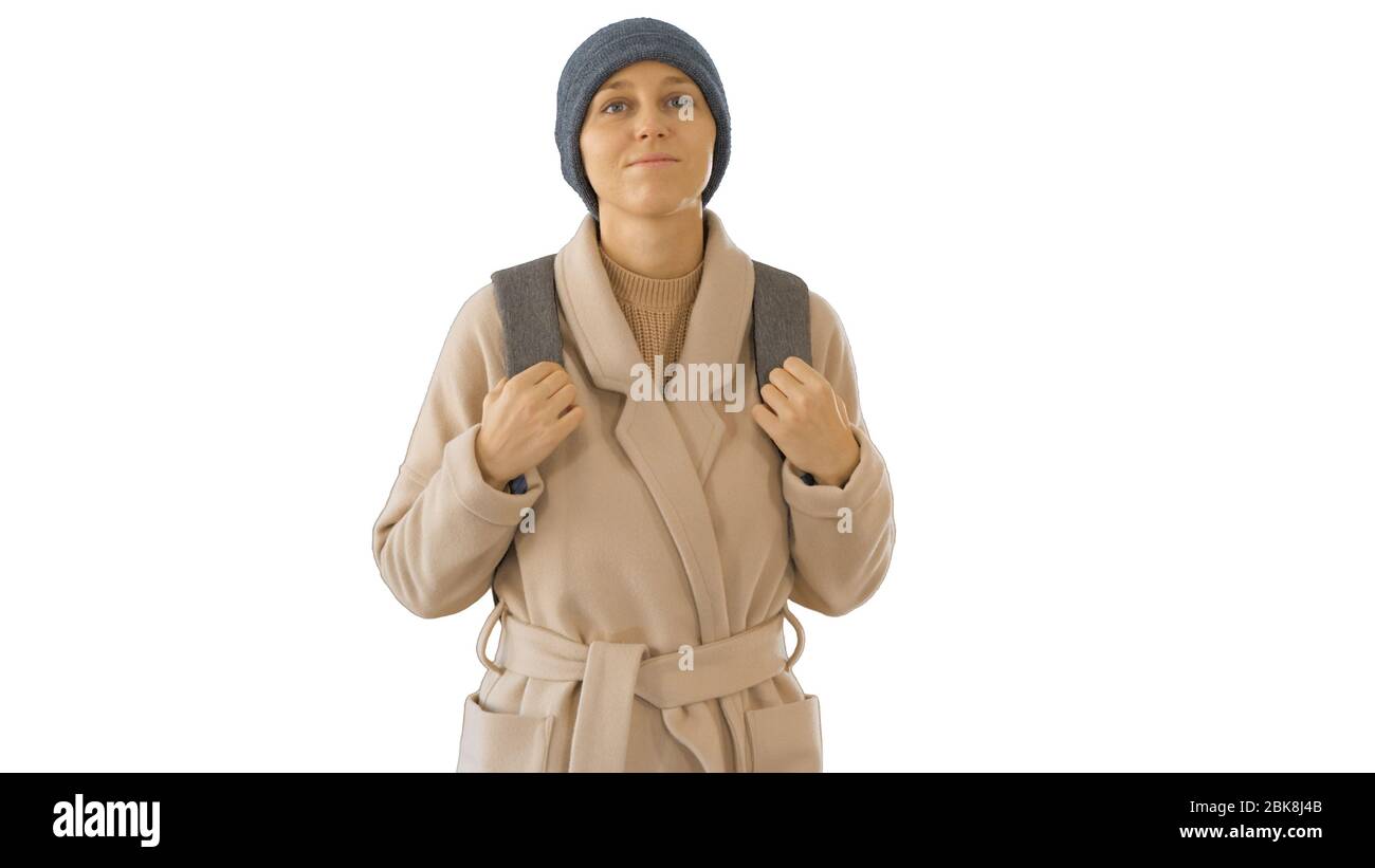 Young woman wearing coat and backpack walking on white background Stock Photo - Alamy