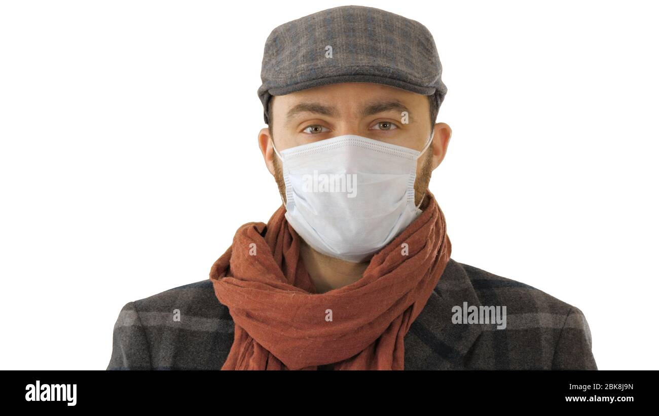 Handsome young European man in trendy coat wearing disposable ...