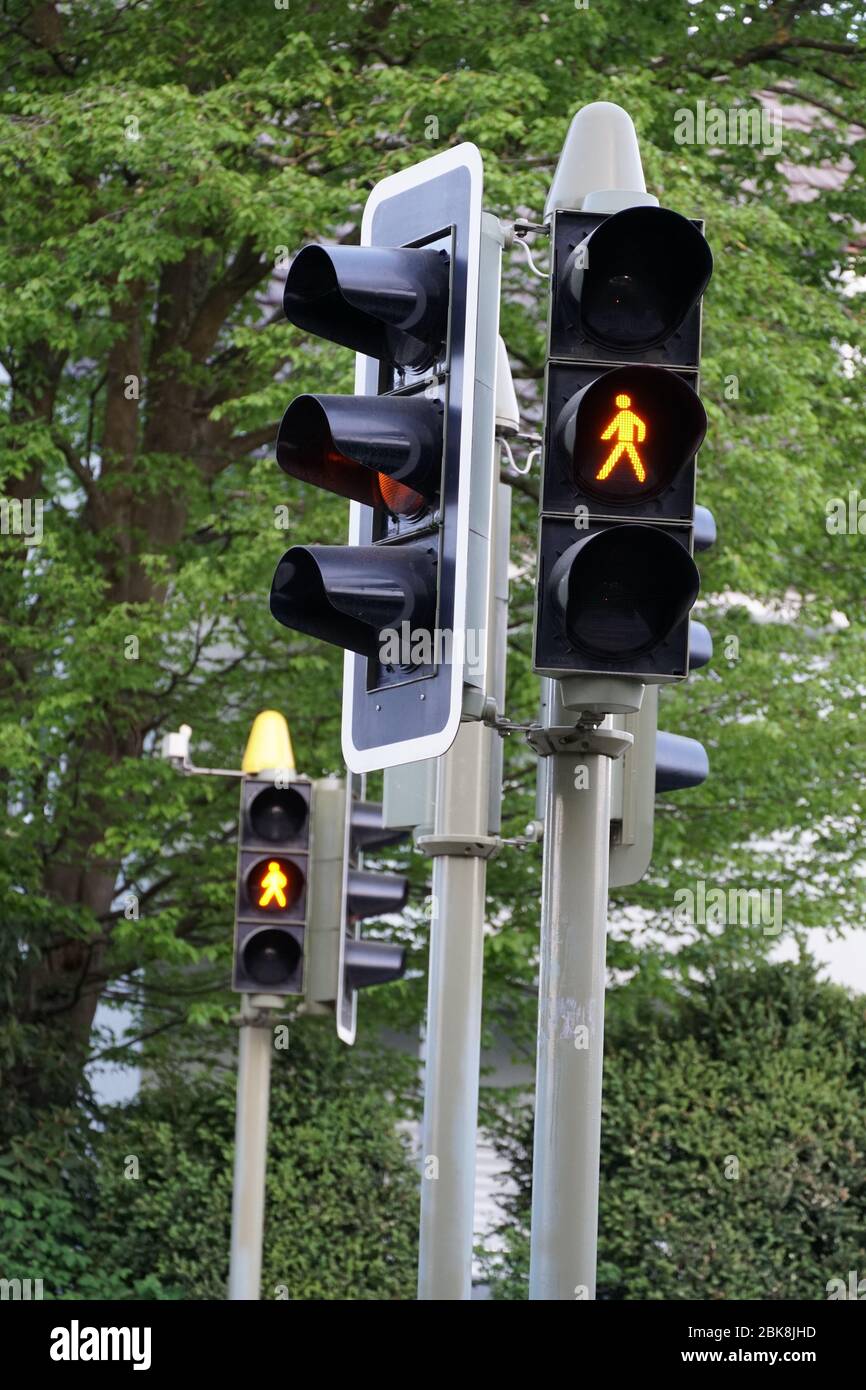 a set of stoplight or traffic lights with an orange light on in a a ...